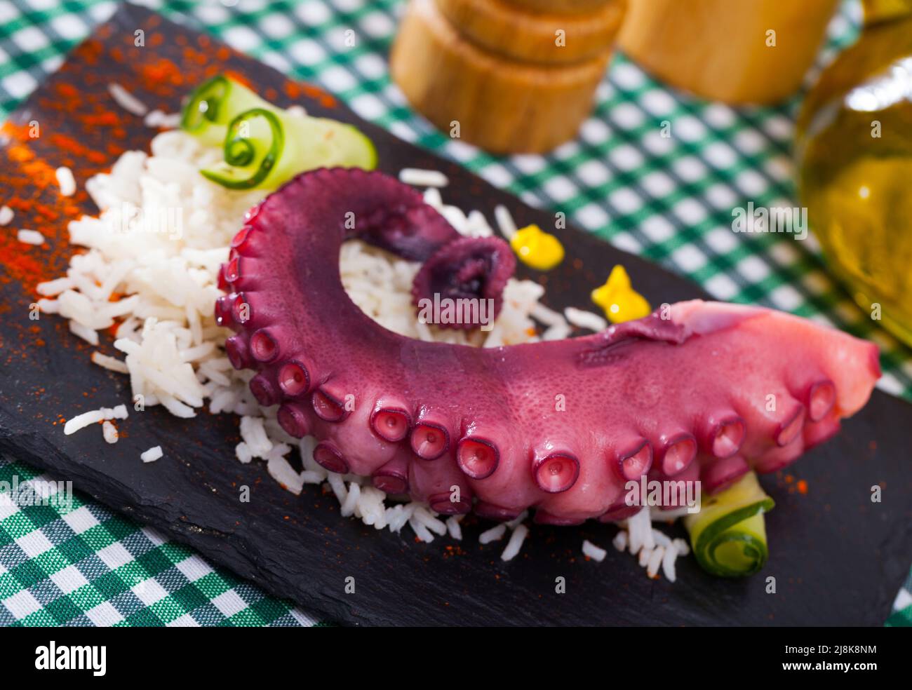 Delicious cooked octopus tentacles on a chopping board Stock Photo - Alamy