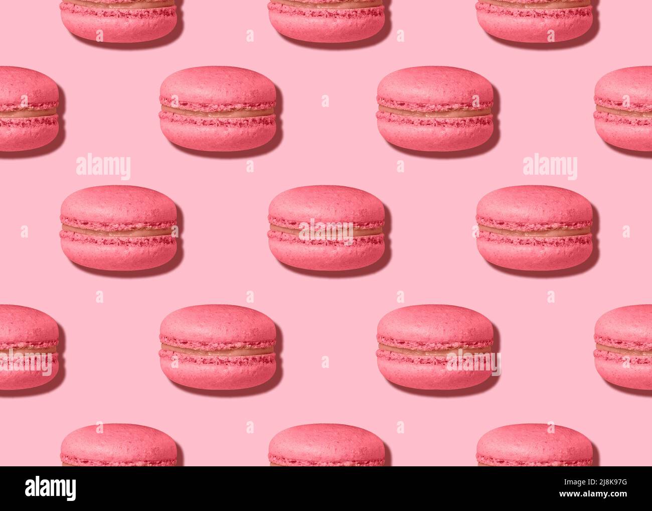 Pink colored french cookies on pastel background Stock Photo - Alamy