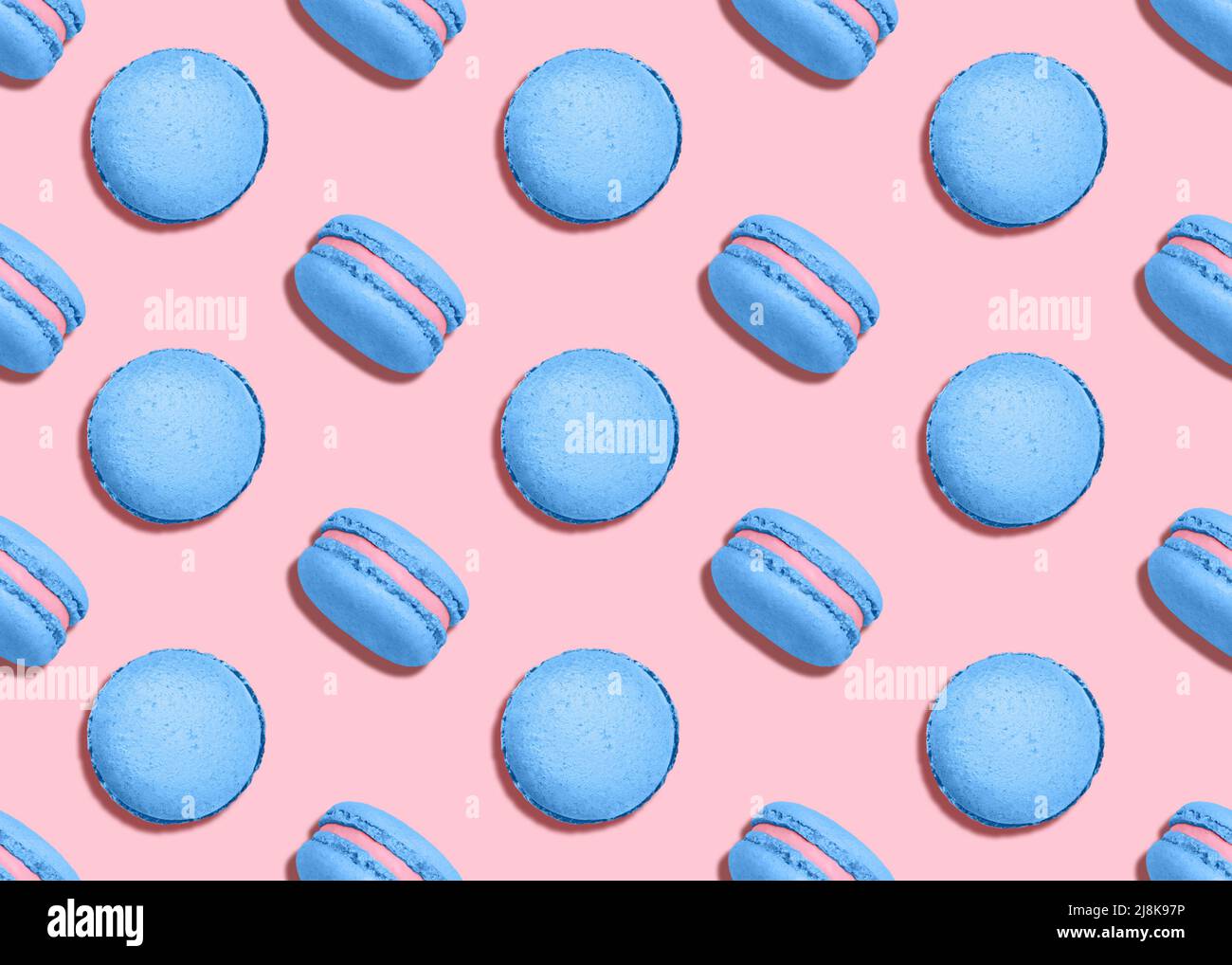 Blue colored macaroons on pastel pink backdrop Stock Photo - Alamy