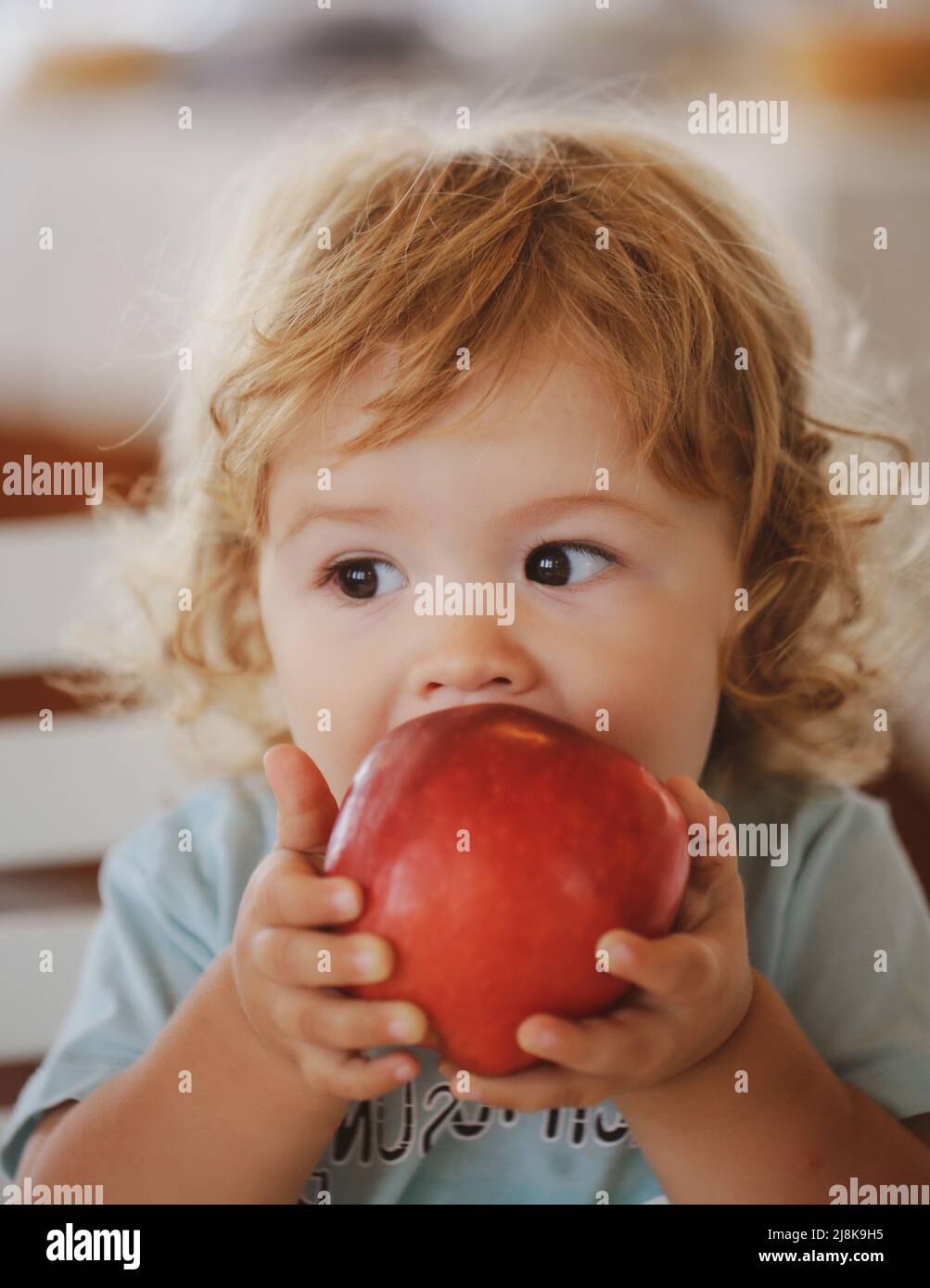 Funny baby eat apple. Kid eating fruit. Little boy biting apple ...