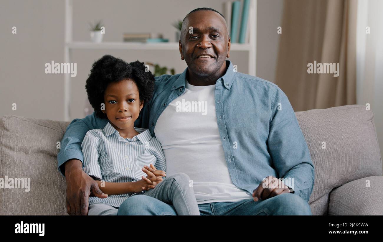 African american family sitting on sofa kid girl waving hello greeting ...