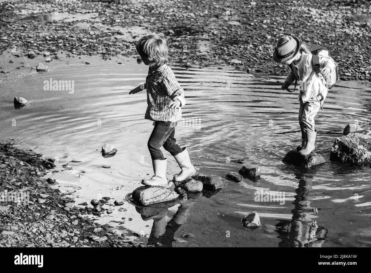 Son and daughter playing in the river. Children playing on mountain ...