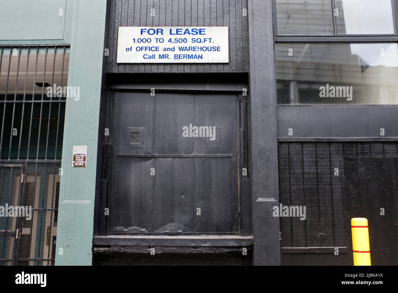"For Lease" Sign above Black Loading Dock Door Stock Photo - Alamy