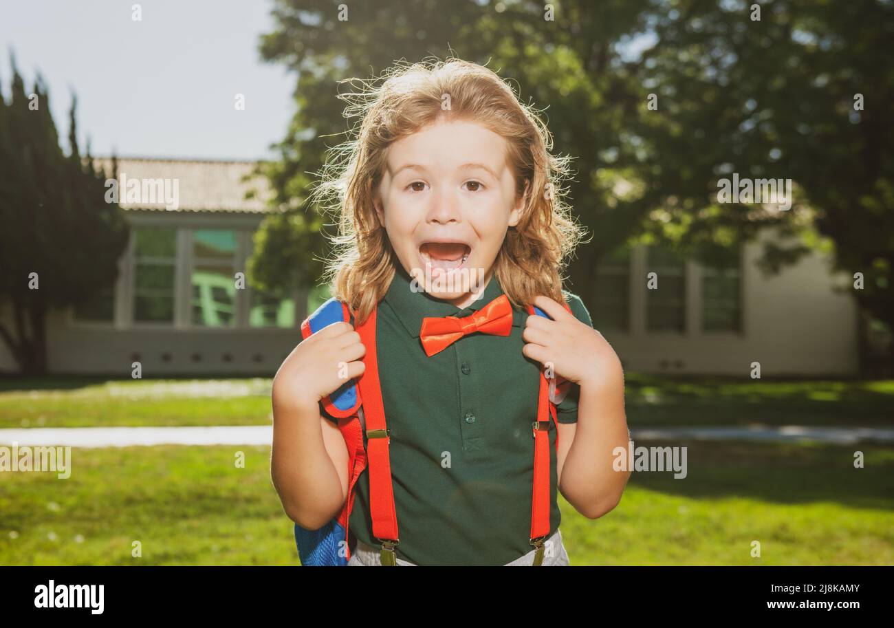 School child concept. Amazed pupil, kid in school uniform with backpack ...