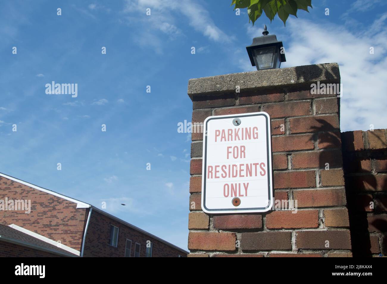 Parking for Residents Only sign on Brick Wall Stock Photo - Alamy