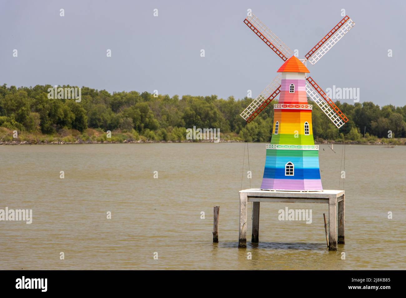 Decorative model of a windmill standing by a wooden structure over ...