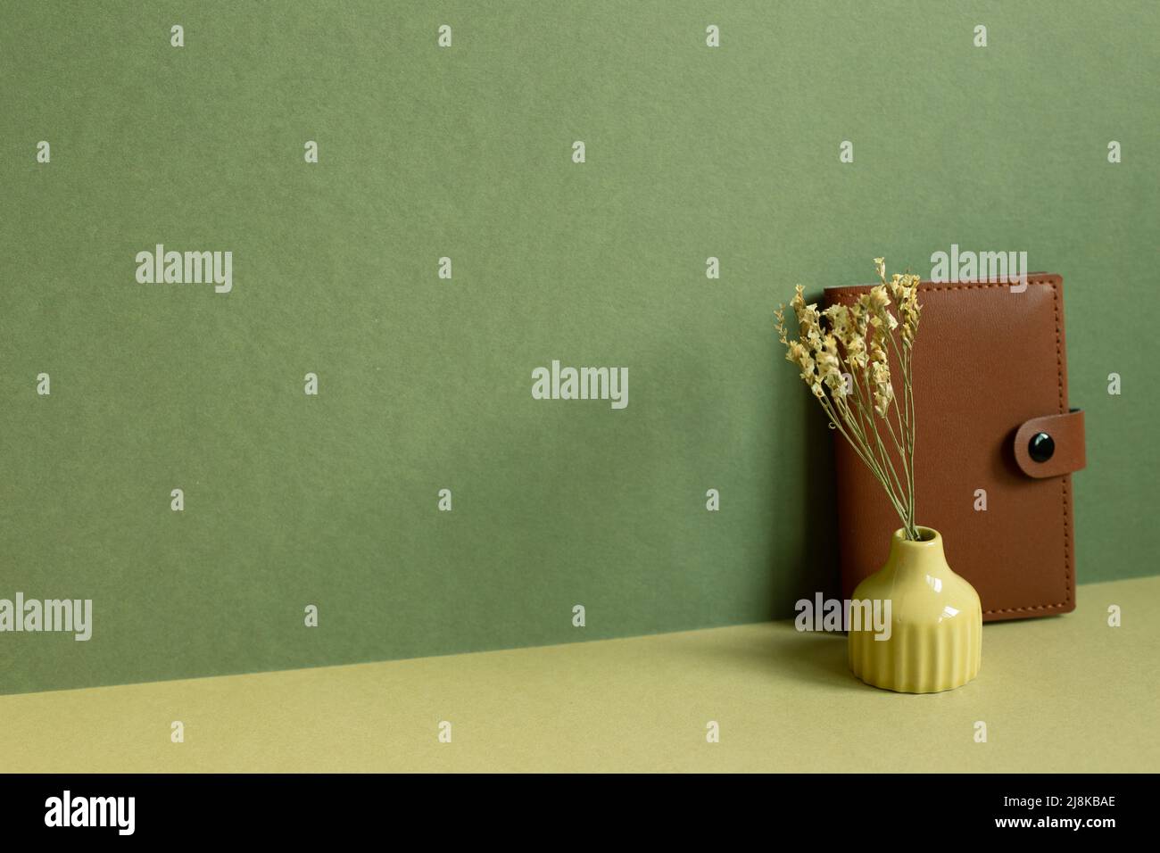 Dairy notebook and dry flower on desk. khaki green background Stock ...