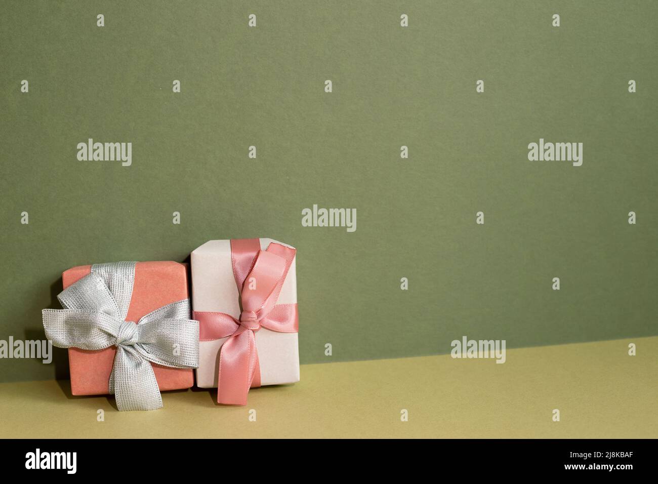 Pink gift box on table. khaki green background Stock Photo - Alamy