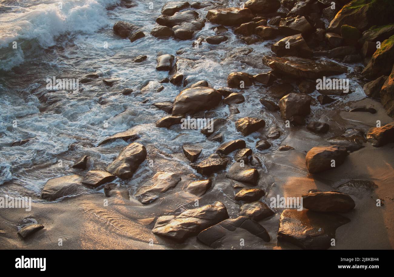 Panoramic view of sunset over ocean. Sea waves lash line impact rock on ...