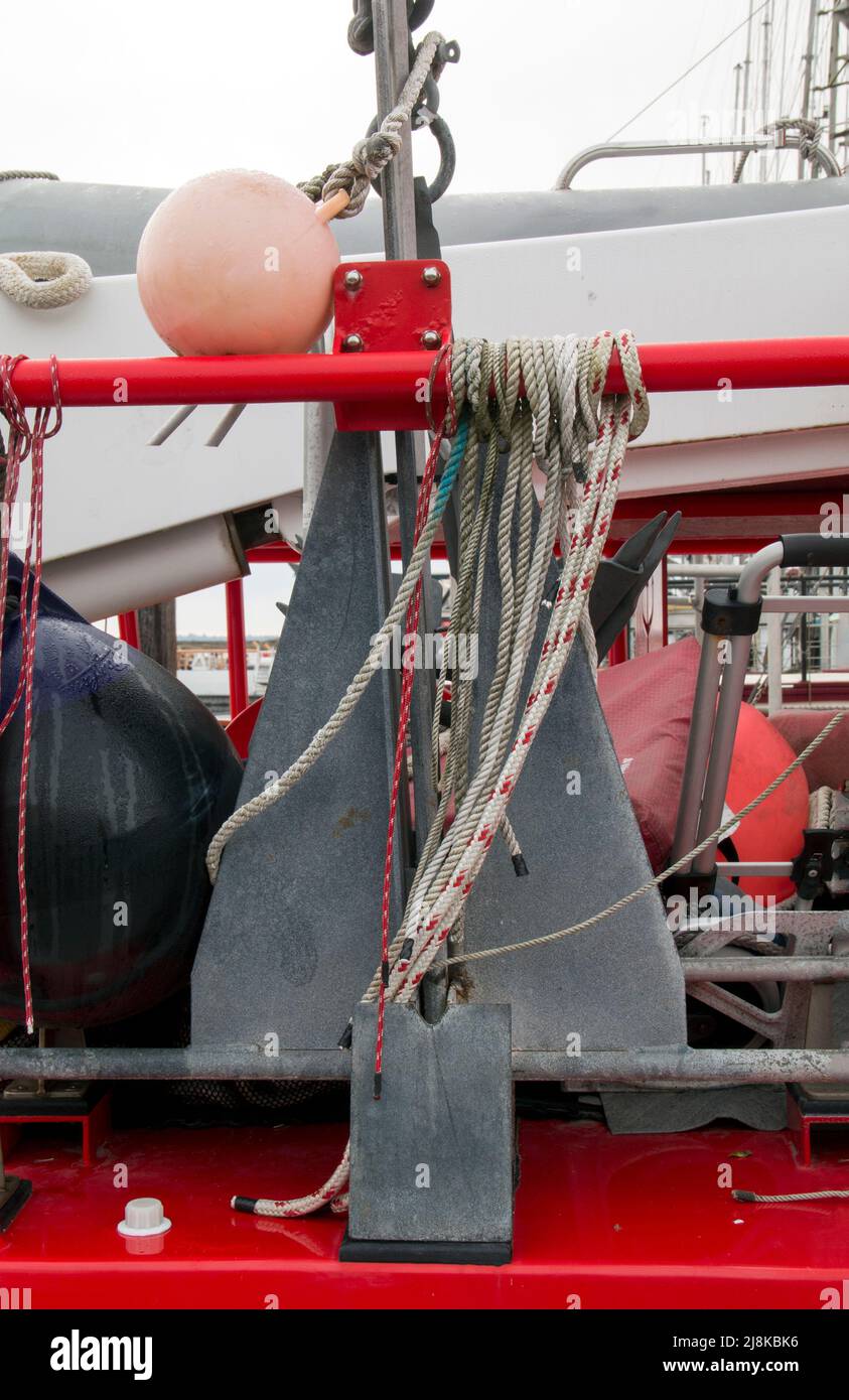 Colorful closeup view of back of boat with anchor and ropes and buoys ...