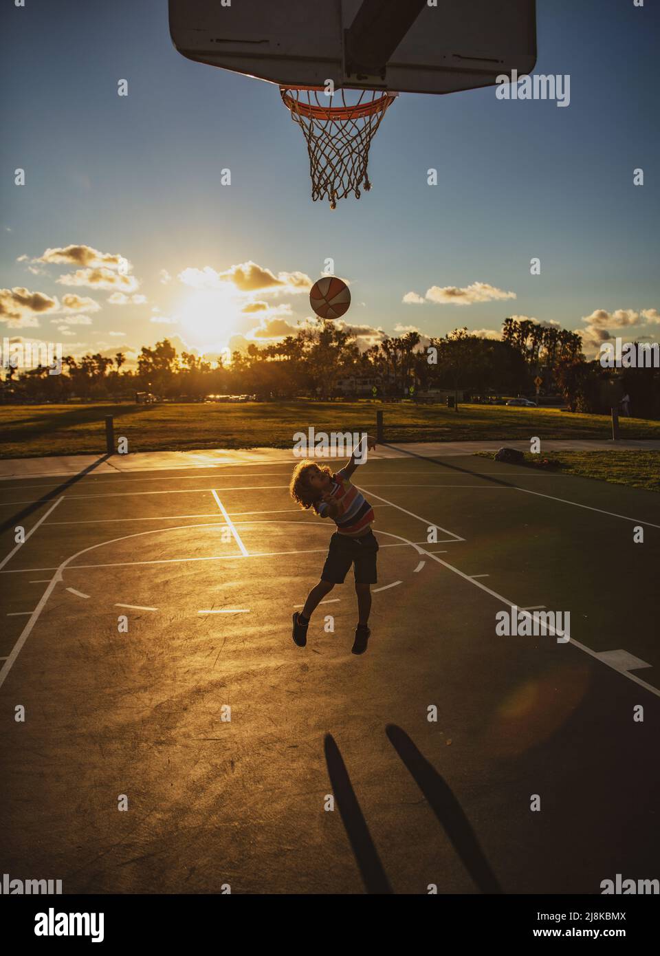 Cute little boy child jumping with basket ball for shot. Little child ...