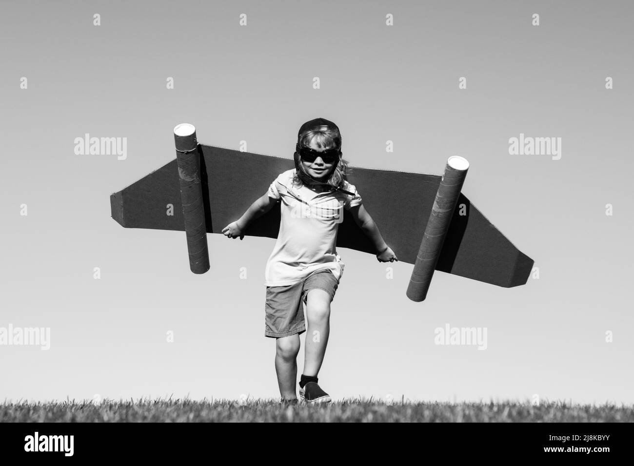 Kid with jet pack superhero. Child pilot against summer sky background ...