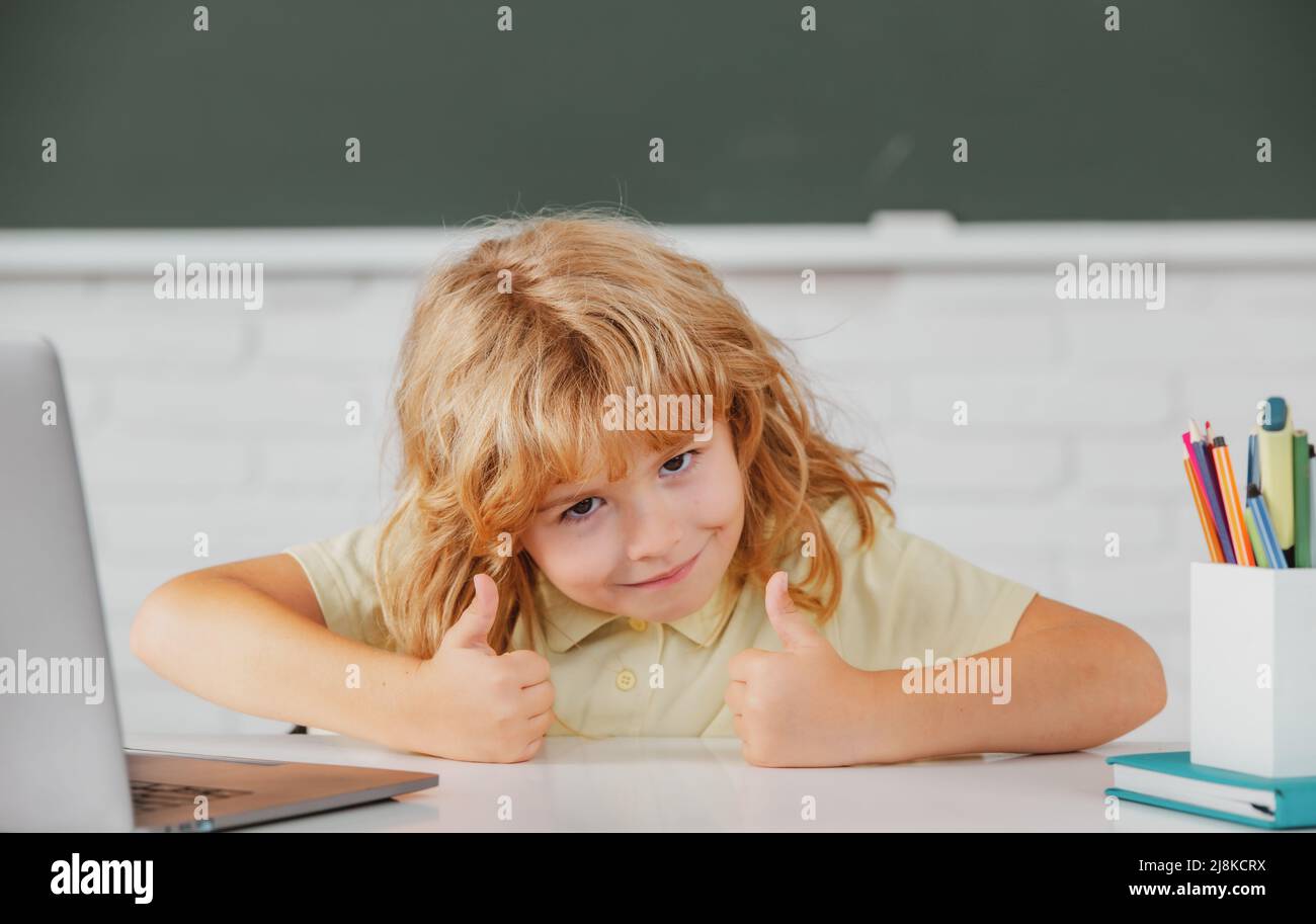 Elementary school kid with thumbs up working in computer class Stock ...