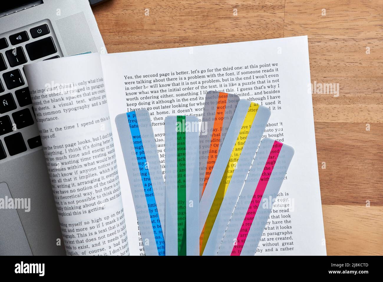 Pack of different colors reading rulers over an open book, coloured ...