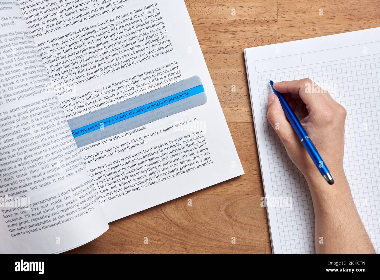 Unrecognizable young person studying with the help of a coloured ...