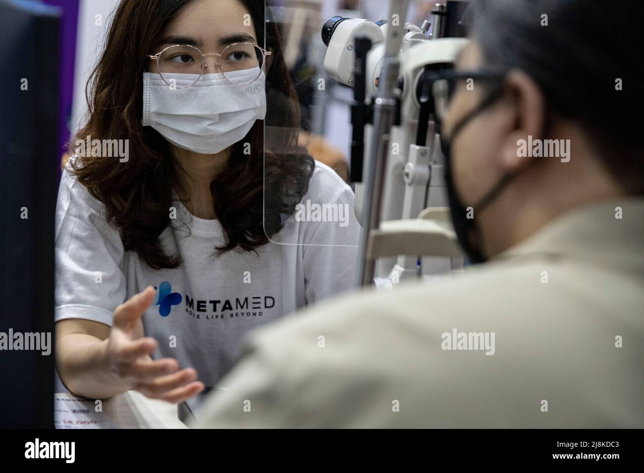 Bangkok, Thailand. 15th May, 2022. A Meta Med employee speaks with a ...