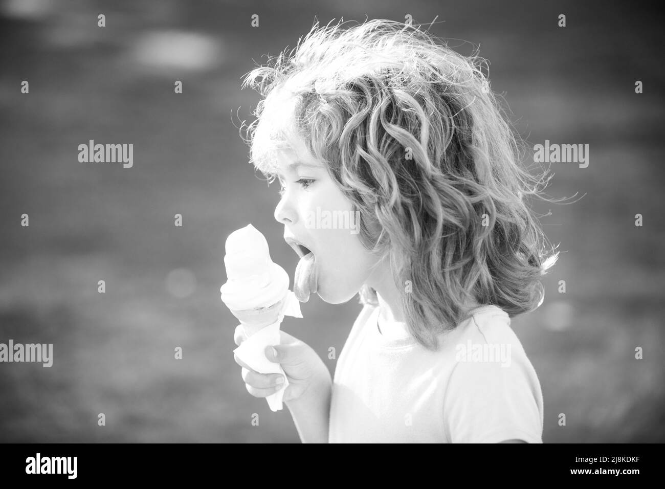Portrait of a cute child boy eating ice cream. Close up caucasian kids ...
