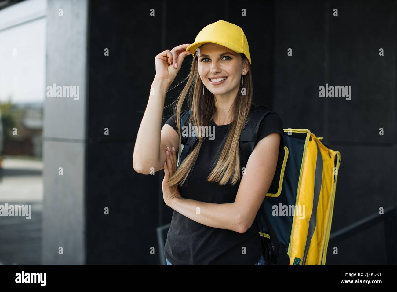 Food delivery, portrait of courier caucasian woman with yellow backpack ...