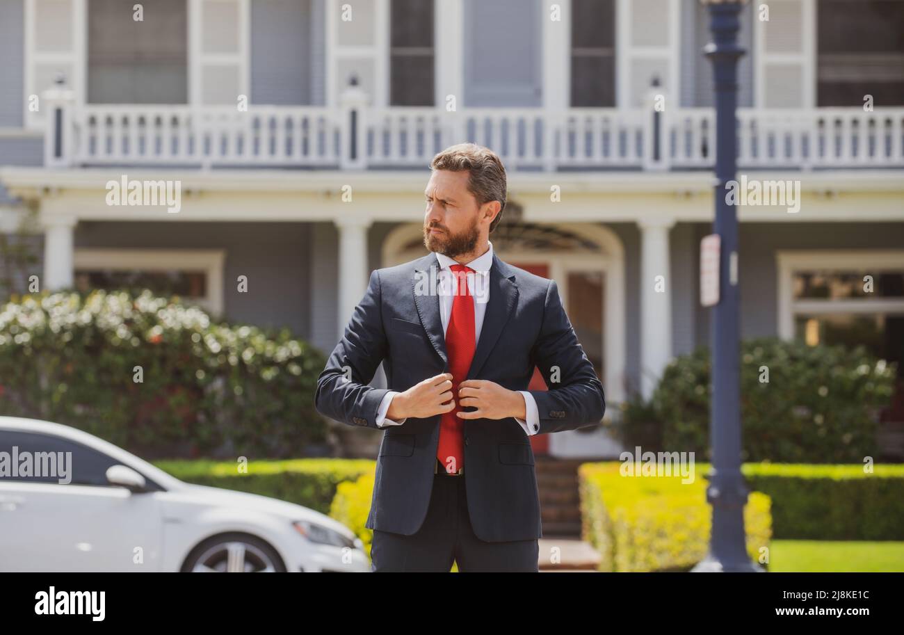 Businessman standing outside a modern house. Real estate concept. Agent ...