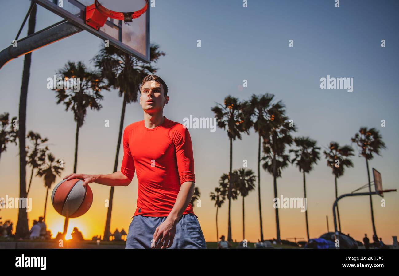 Basketball player. Sports and basketball. Sunset sky and court in the ...