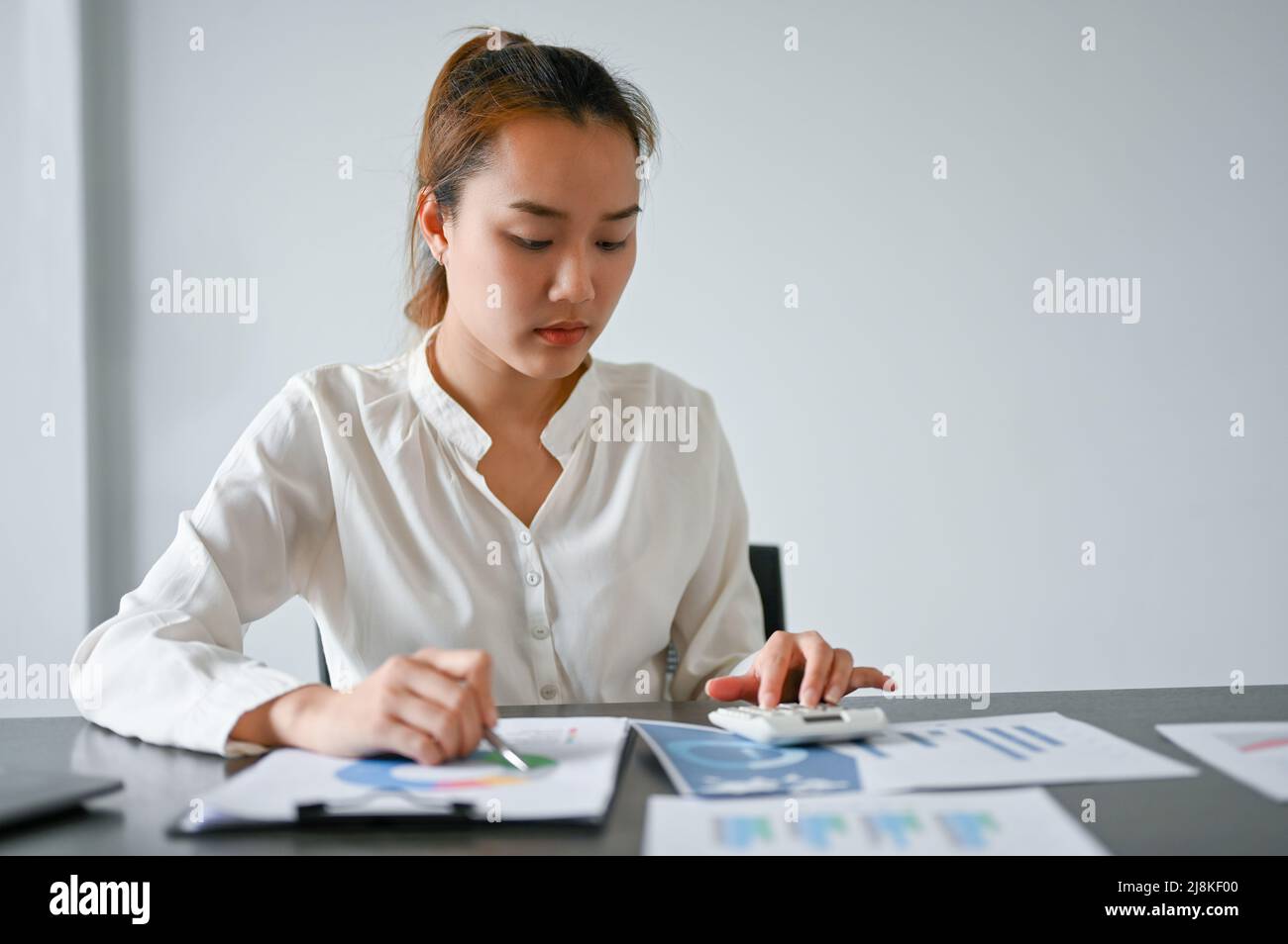 Female financial manager reviewing a business financial investment ...