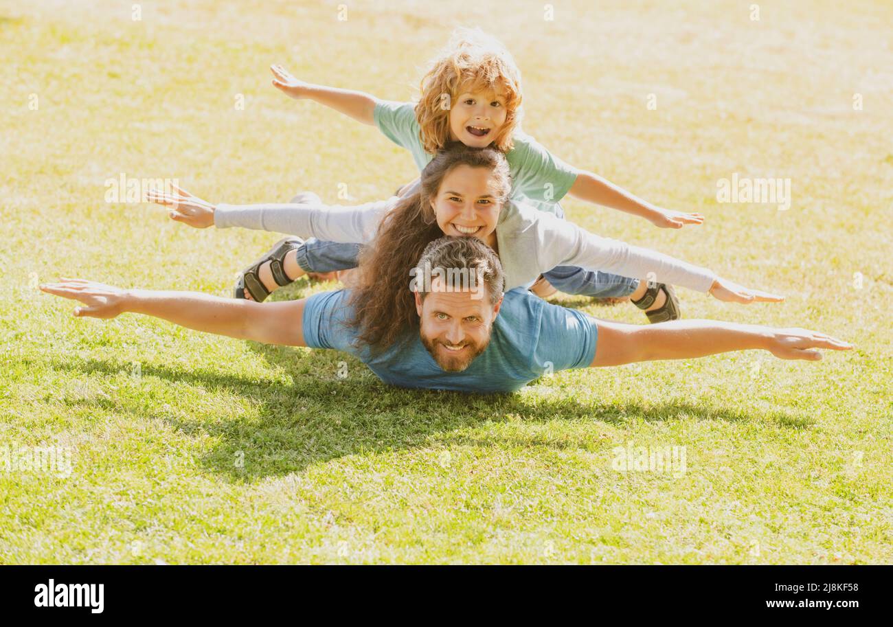 Young family with child having fun in nature. Fly concept, little boy ...