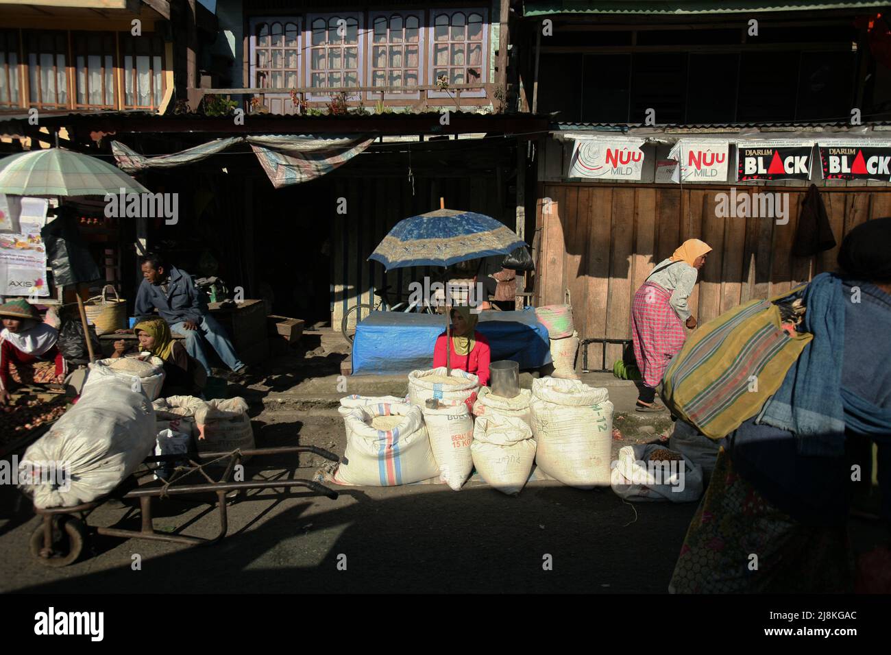 A woman selling rice at a roadside traditional market in Kersik Tuo ...