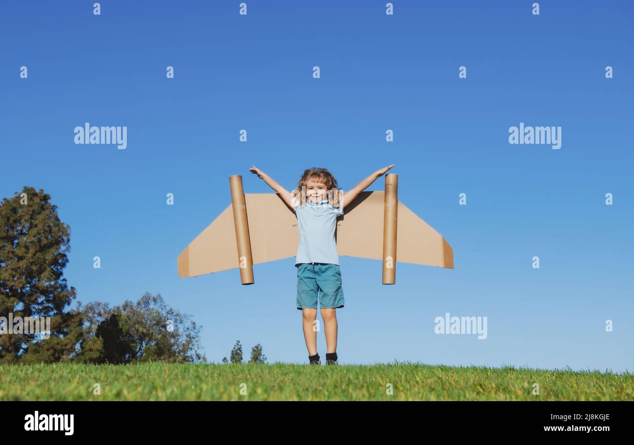 Boy child with wings at sky imagines a pilot and dreams of flying. Kids ...