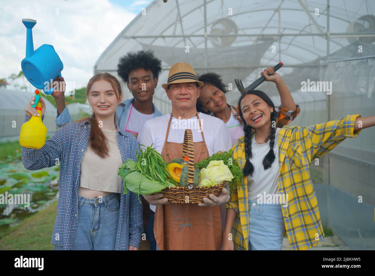 group of young diverse people enjoy activity in plantation at organic ...