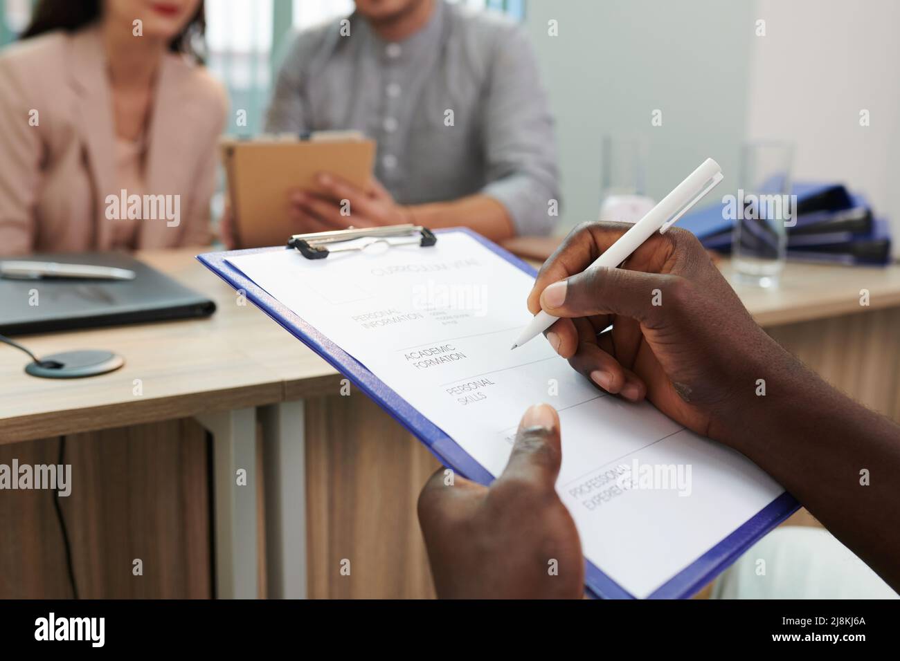 Close-up image of job seeker filling application form before interview ...