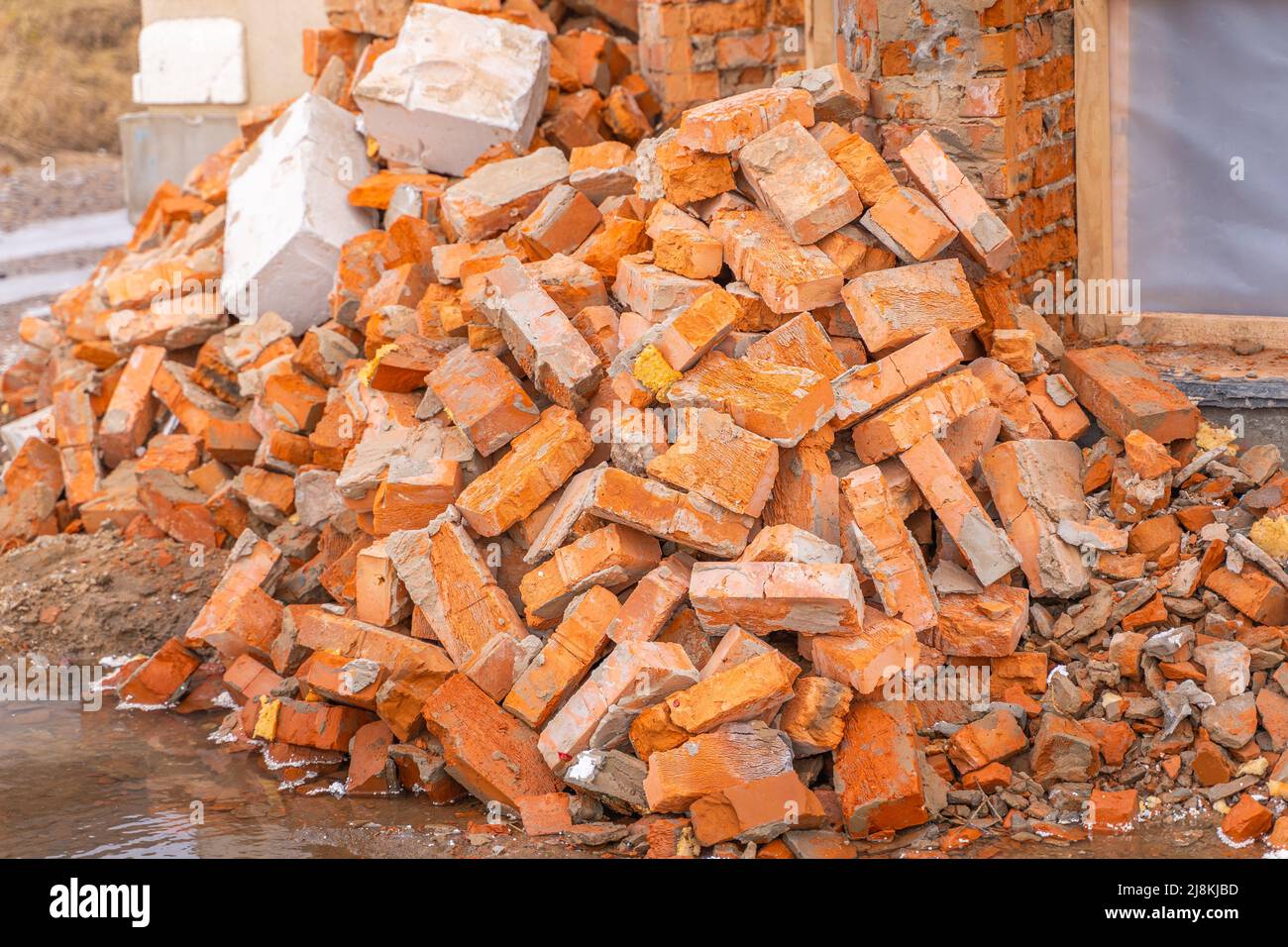 Building red ceramic bricks thrown into the garbage. Construction ...