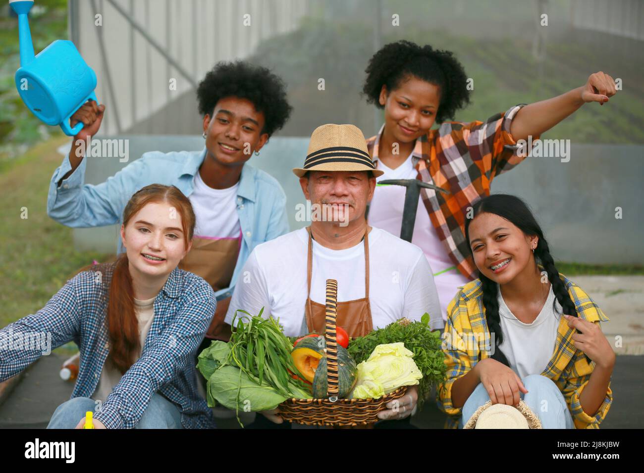 group of young diverse people enjoy activity in plantation at organic ...