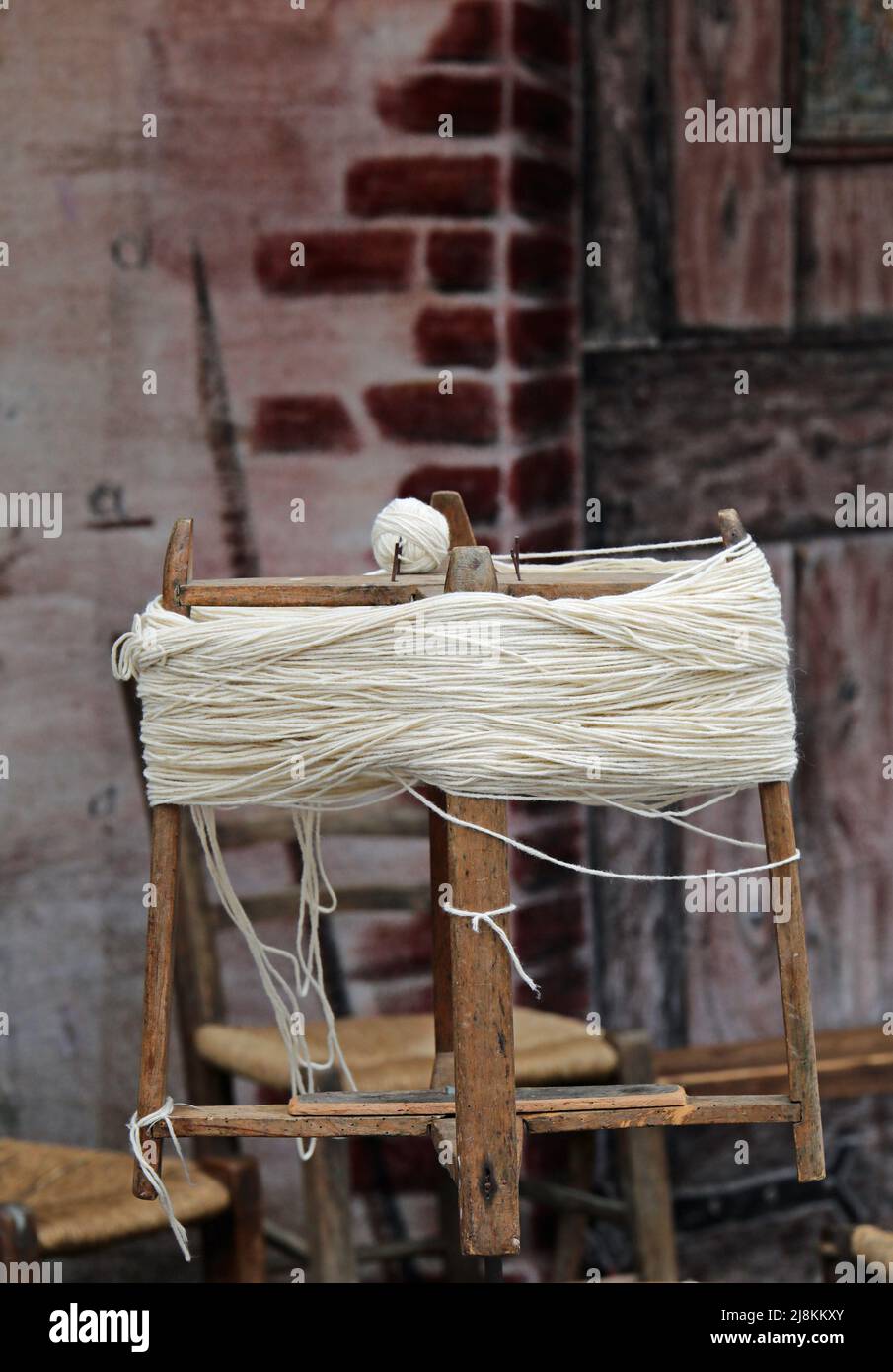 ball of raw wool just made with an old wooden spinning wheel by the ...