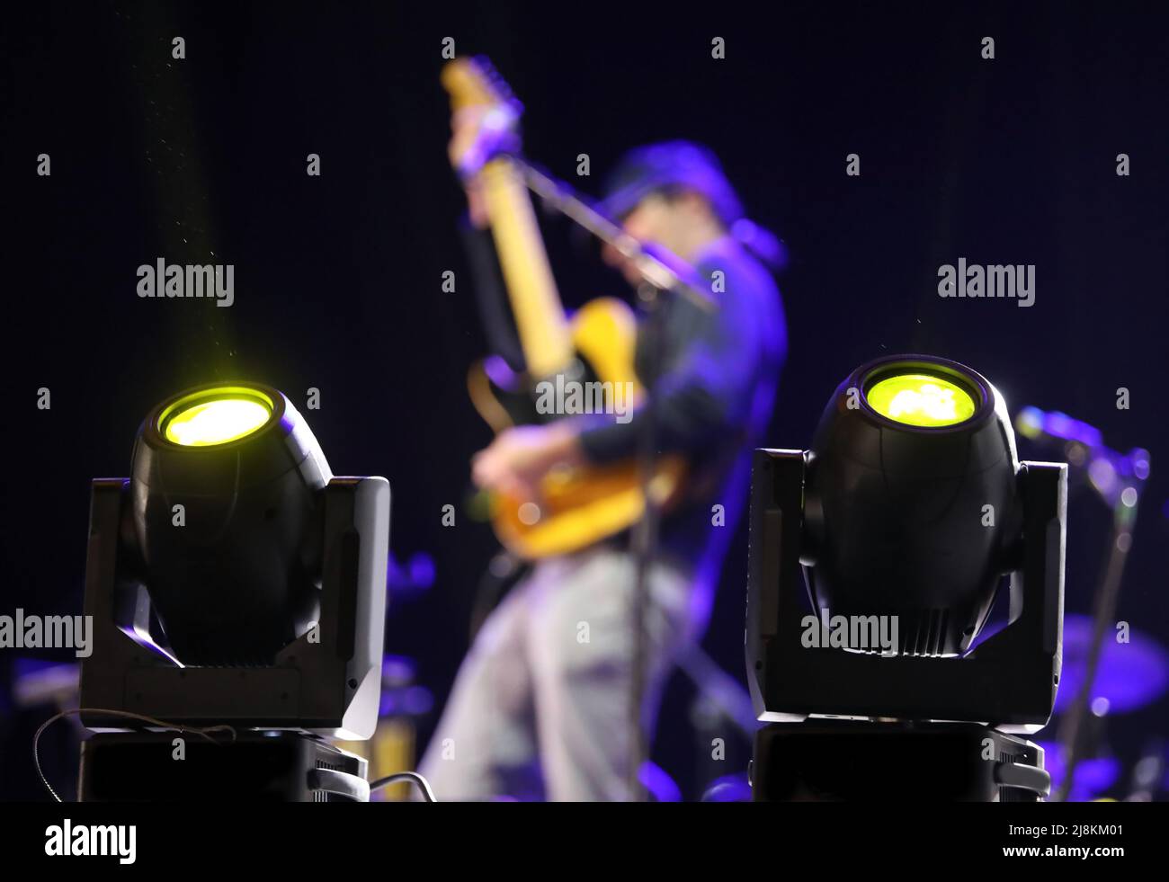 two spotlights in the stage during a live concert and the musician ...