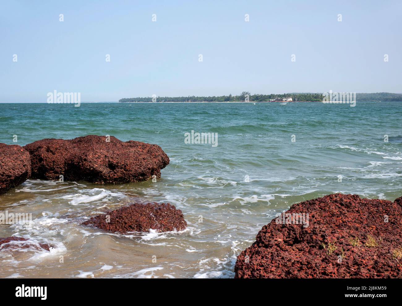 Sea waves and Laterite rock (Red Jambha stone) on Bhowe beach state ...