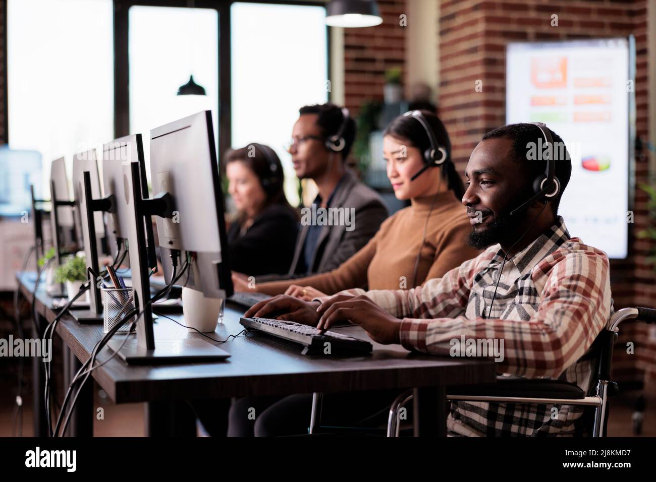 African american helpdesk receptionist with chronic impairment working ...