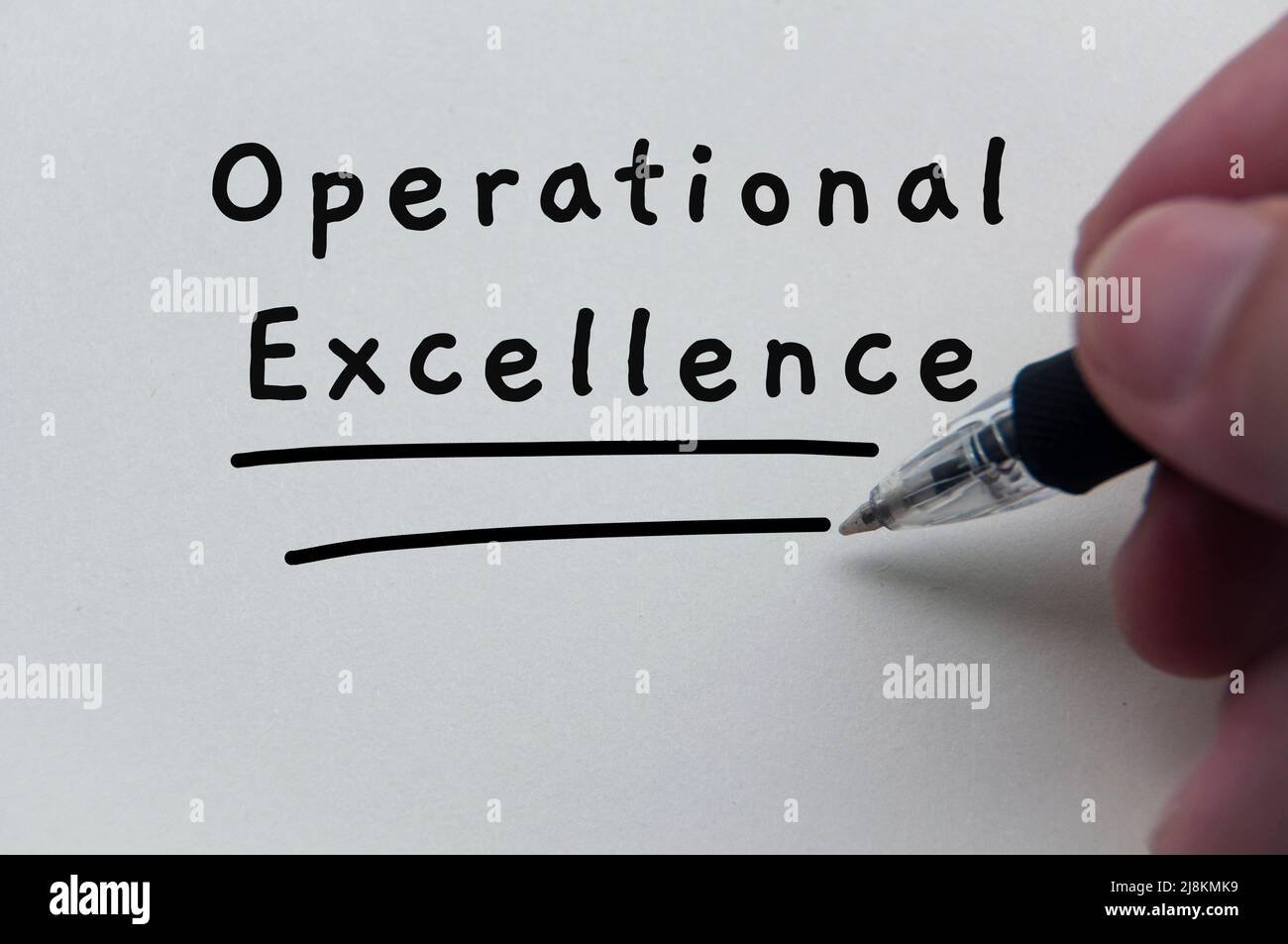 Hand writing operational excellence on notepad. Business strategy ...
