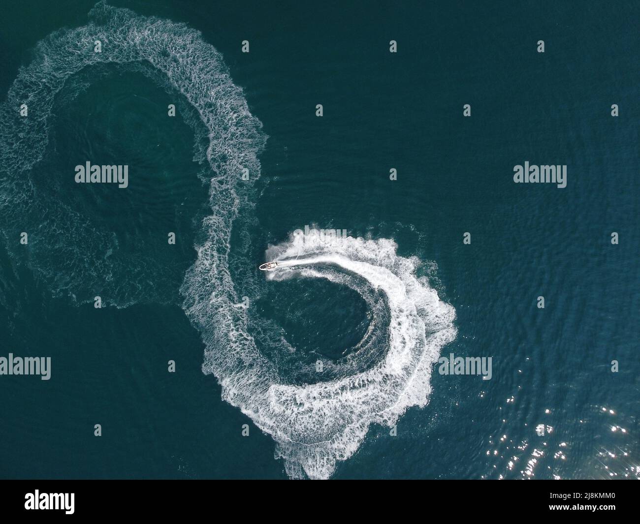 Aerial top down view of water foam trace with nice deep blue shade of ...