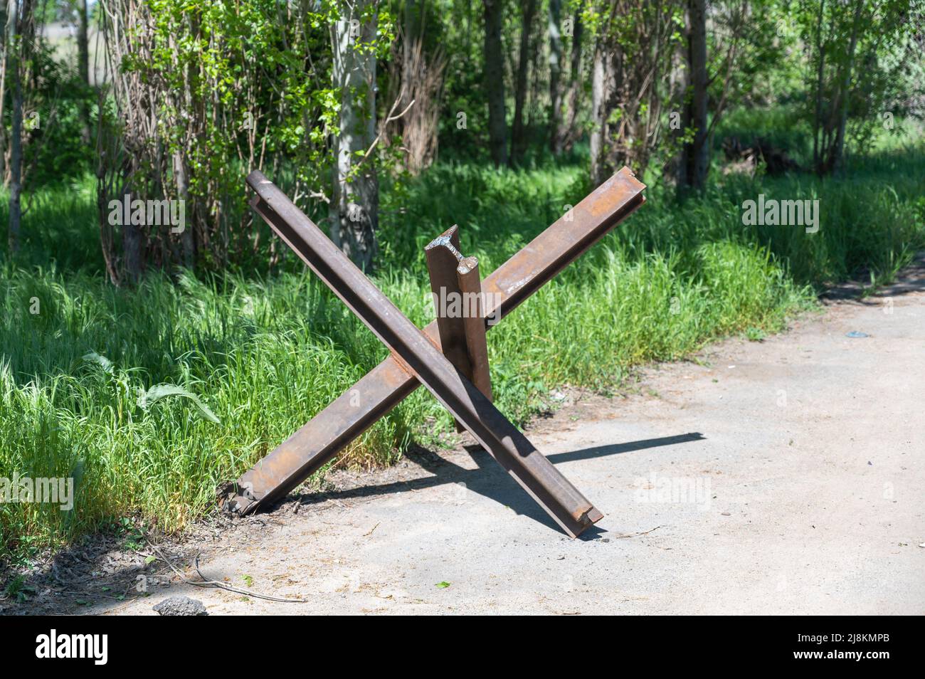 Anti-tank obstacles in the street of a Ukrainian city. Metal barrier ...