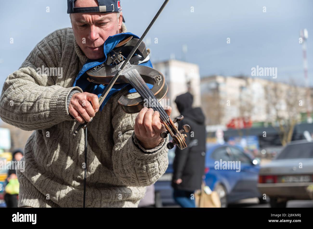 Portrait of a street musician during a concert. A mature man playing ...