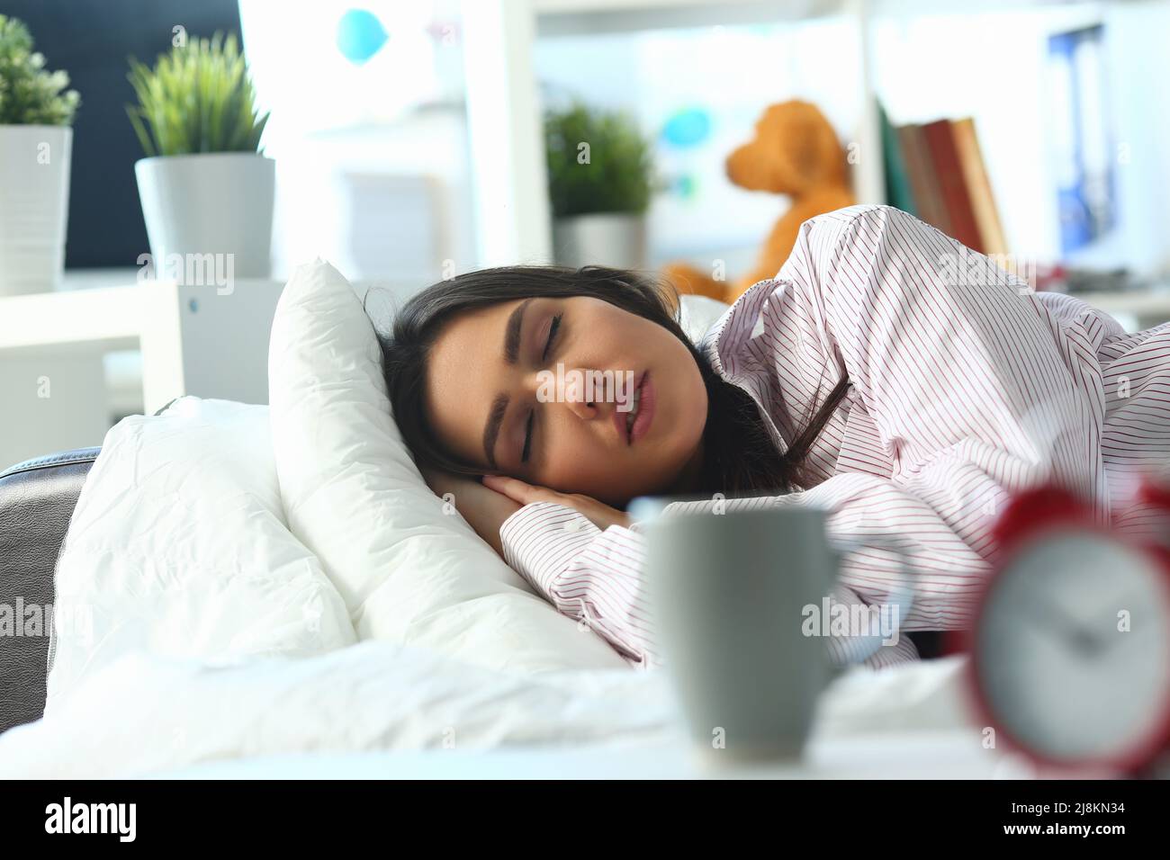 Young woman peacefully sleeping in bed, tired female, tough night ...