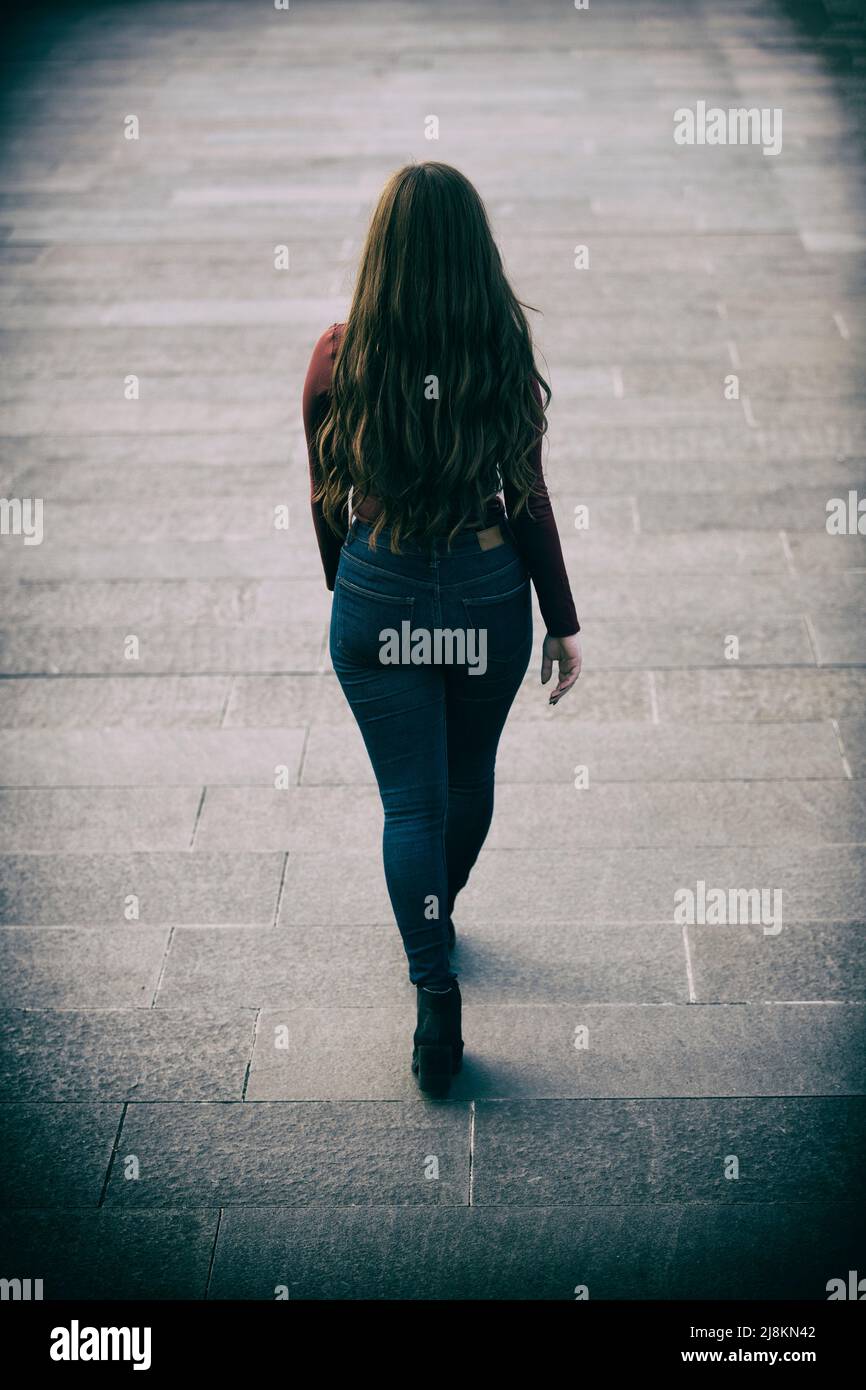 Rear view of woman walking away Stock Photo - Alamy
