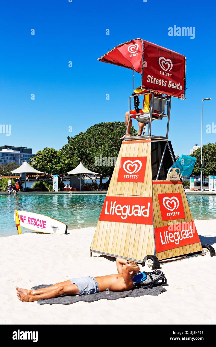 Brisbane Australia / A young man enjoys the sunshine at Streets Beach ...