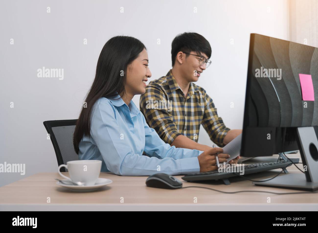 Young asian partner programmers working in team while making a new ...