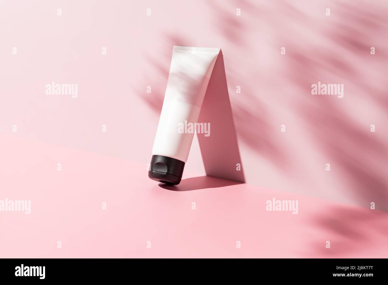 white cosmetic tube for face or body cream, cleanser or shampoo on a ...