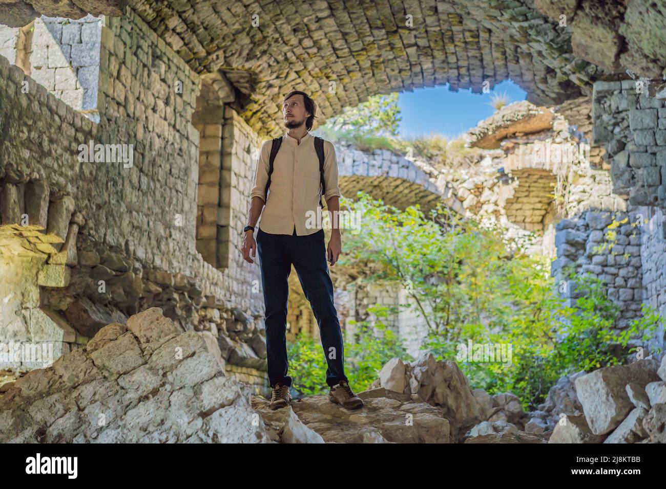 Male traveler in Collapsing tower of fortress Kosmac. Ancient Austro ...