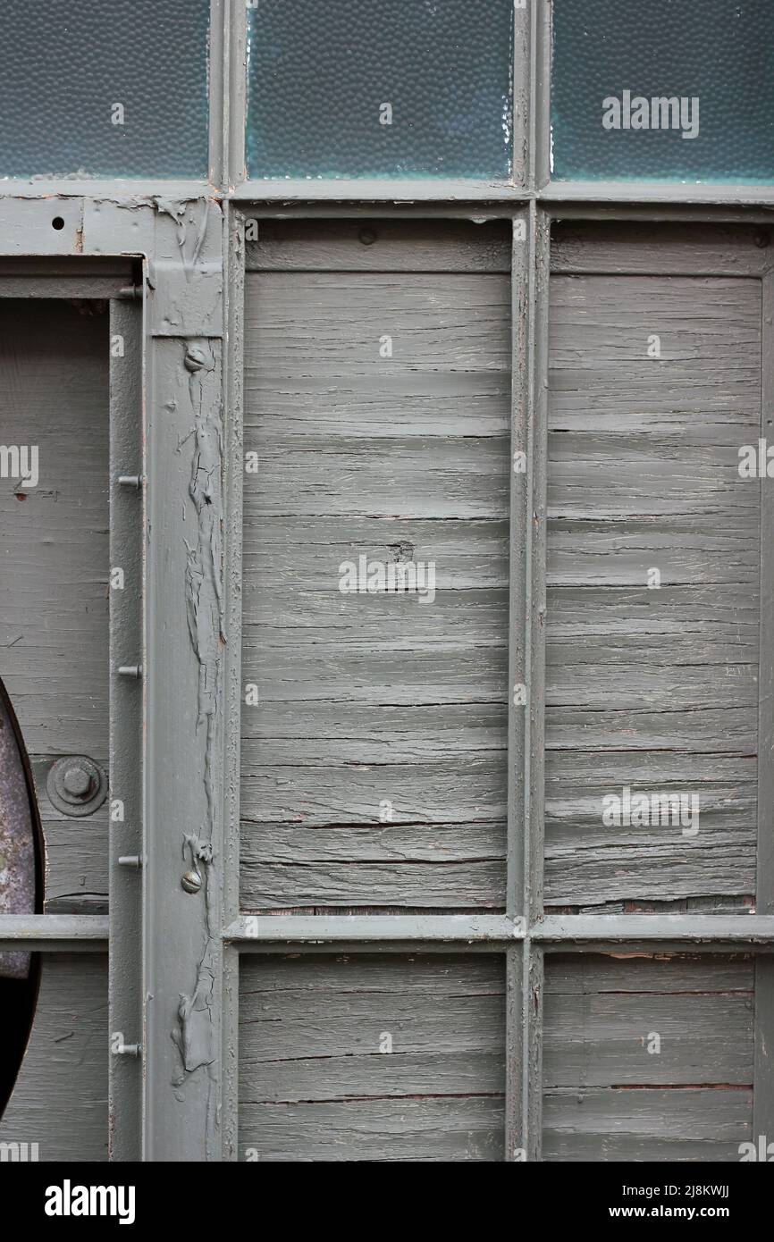 Broken window of an abandoned factory fixed with plywood infill Stock ...