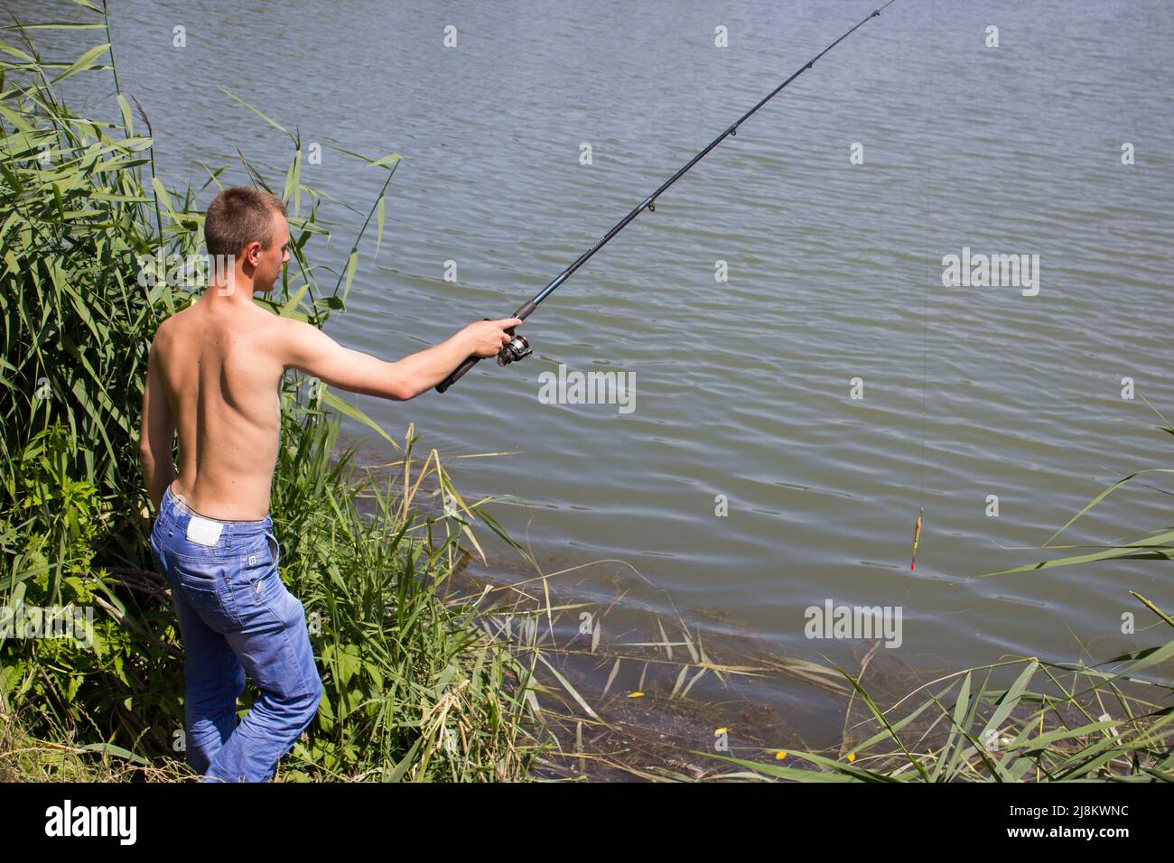 Fisherman fight against a sea bass man with rod Stock Photo - Alamy