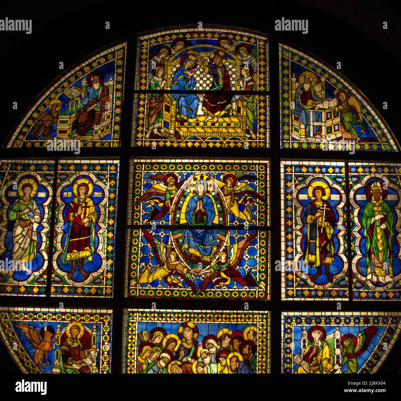 Light through stained glass rosettes, representing religious images ...