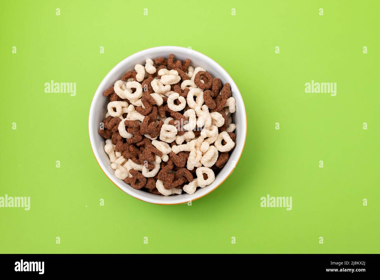 simple and chocolate cereals letters in orange bowl Stock Photo - Alamy